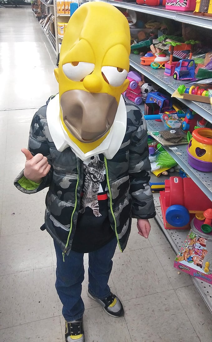 Nothing says "thrift store magic" like trying on a Homer Simpson mask while contemplating your life choices among plastic toys.