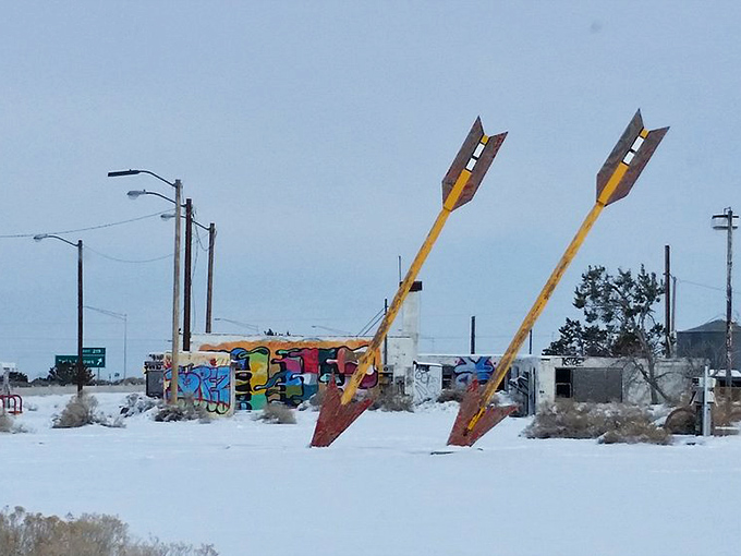 Even blanketed in winter white, the arrows maintain their vibrant defiance against time, weather, and interstate bypasses.