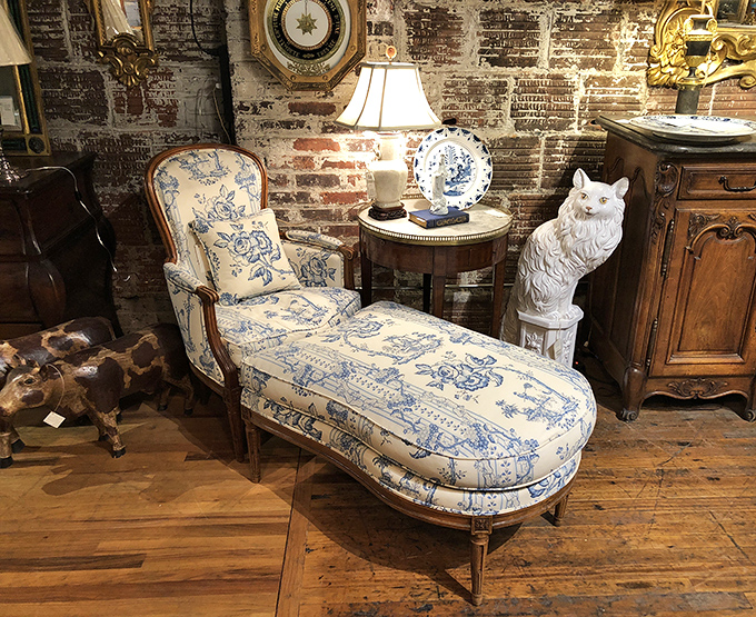 The blue and white chaise lounge that whispers, "Draw me like one of your French girls," while the ceramic cat stands guard over your afternoon naps.