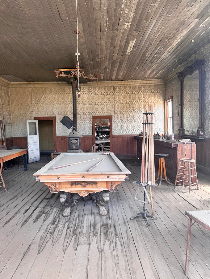 The pool table sits ready for a game that's been postponed for over a century now.