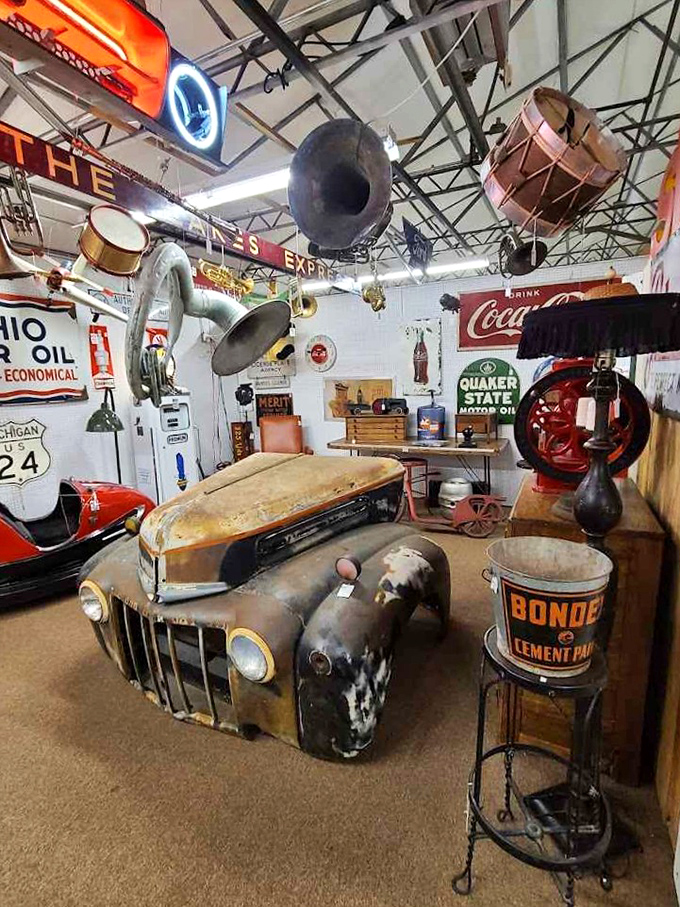 Vintage automotive dreams come to life in this booth where a weathered truck front end serves as the ultimate conversation piece.