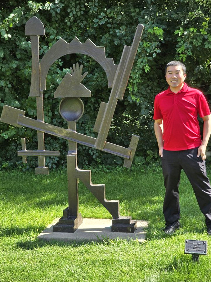 Art that invites interaction creates the most memorable experiences. This geometric metal sculpture plays with perspective and possibility.