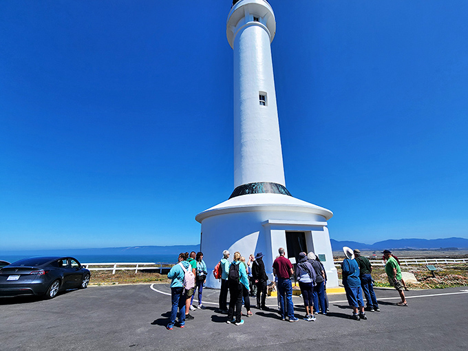 Tour groups gather for lighthouse wisdom before the climb. That look of anticipation says: "145 steps? I should have skipped that second pastry." 
