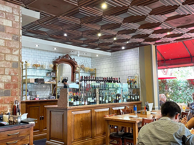 A bar that understands the sacred relationship between pasta and wine, with bottles standing ready like soldiers prepared for delicious duty.