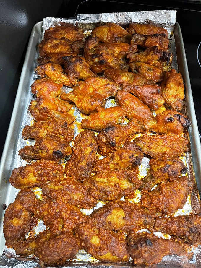 A tray of wings so perfectly cooked they could make a vegetarian question their life choices. Golden-brown perfection waiting to be devoured.