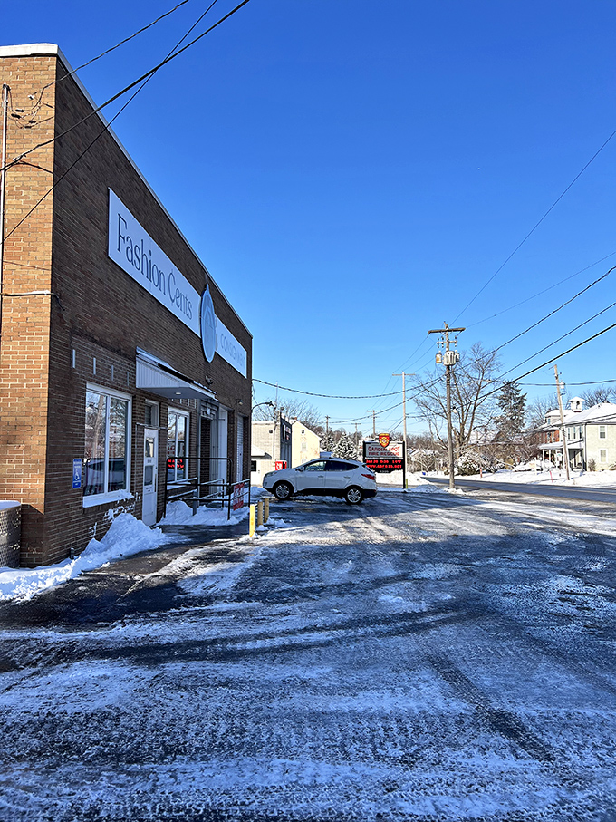 Blue Ball's Fashion Center stands against a winter sky, its simple brick facade dusted with snow.