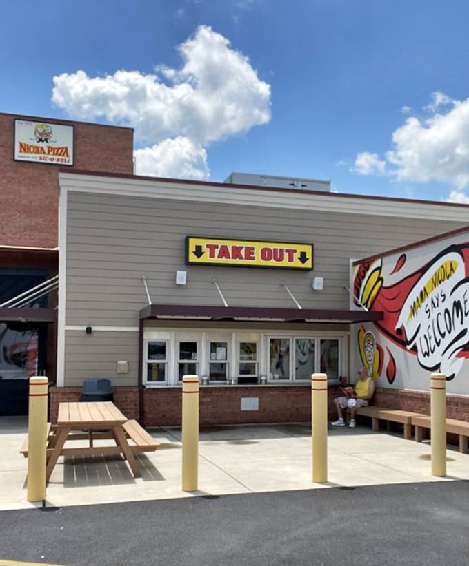 Nicola's colorful mural celebrates the iconic Nic-o-Boli. When your pizza is famous enough to paint on walls, you know it's special.