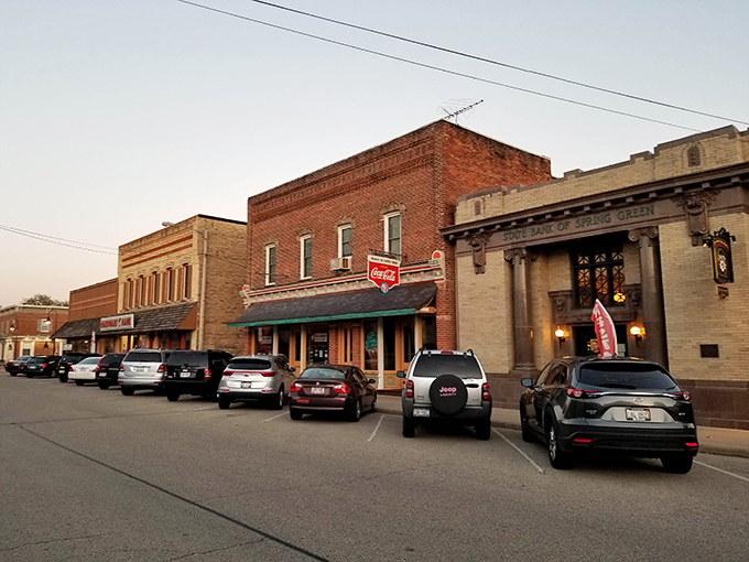 Historic brick buildings line Spring Green's main street, where the vintage Coca-Cola sign reminds visitors that some things never go out of style.