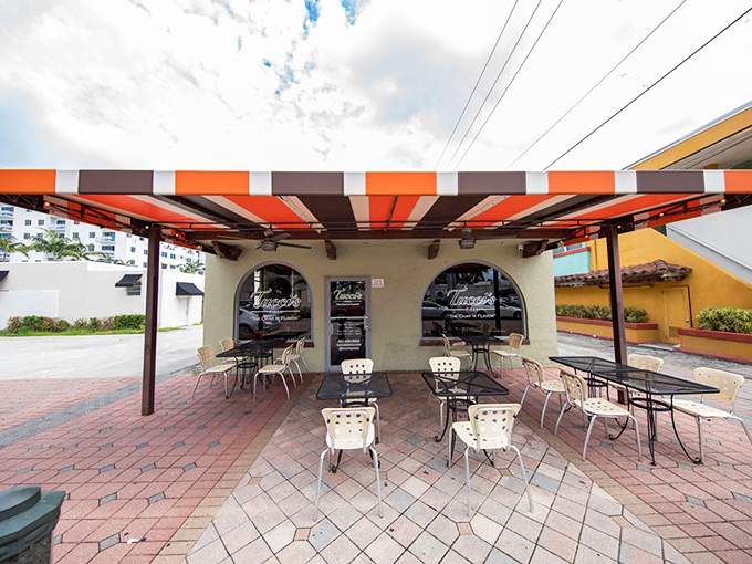 Tucci's Fire N Coal Pizza: That striped awning and outdoor seating area promise pizza with a side of Florida sunshine.