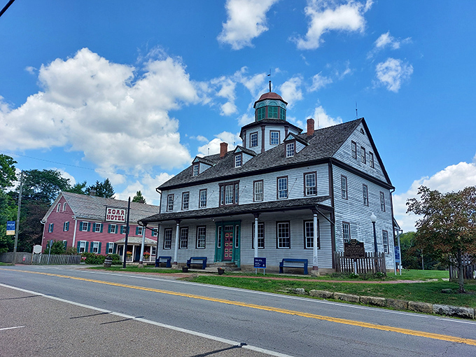 Zoar's historic buildings stand proudly under a bright blue sky, their timeless charm highlighted by the crisp daylight and fluffy clouds above this preserved village.