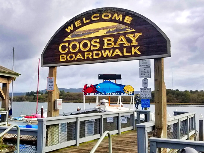 The wooden sign may say "Welcome to Coos Bay Boardwalk," but it really means "Welcome to coastal retirement you can afford."