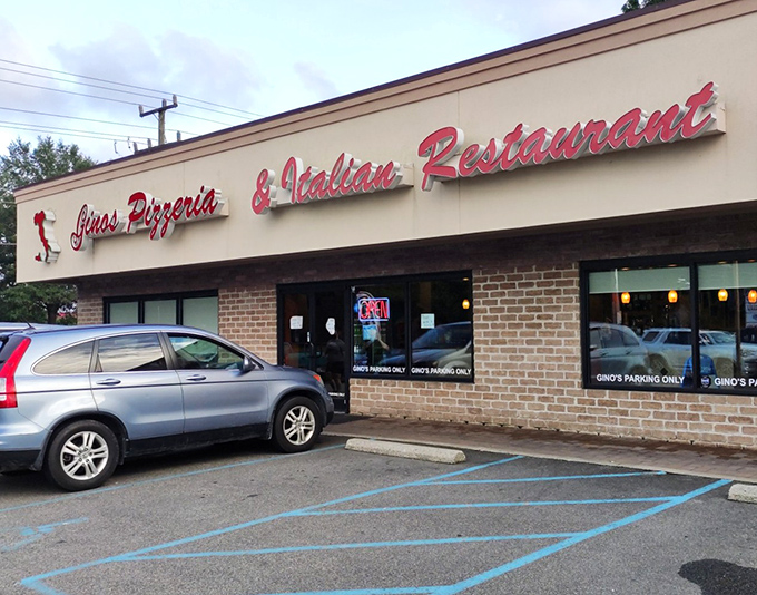Red lettering against beige &ndash; nothing fancy here except the flavors. Gino's focuses on what matters: perfect pizza, not flashy decor.