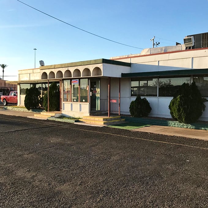 The classic white arched windows aren't just architectural details &ndash; they're frames for the daily drama of perfect eggs and endless coffee.