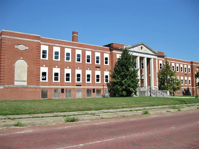 Once filled with the sounds of shuffling papers and school bells, this classic brick schoolhouse now stands as a monument to education's past.