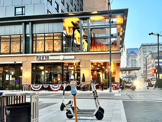 City lights frame Pier 48's inviting entrance at dusk. Where downtown energy meets seafood serenity &ndash; no passport required!