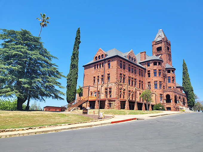 Preston Castle: Massive brick walls and Gothic windows stand proudly against the blue sky&mdash;a red sandstone giant with stories to tell.