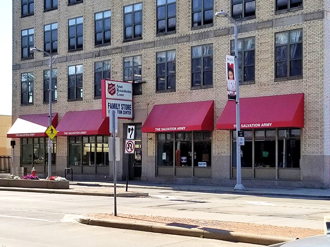 Those bright red awnings pop against the classic brick facade. A century of helping the community, one fantastic find at a time.