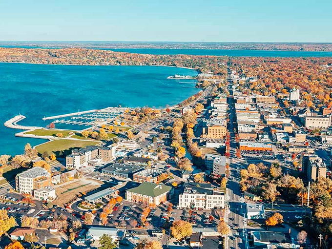 Autumn colors frame Traverse City in nature's most spectacular light show. From this height, you can almost taste the cherry pie waiting in town below.