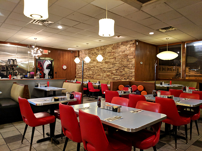 Mid-century charm meets timeless comfort. The stone wall and wood paneling create the diner equivalent of a warm hug.