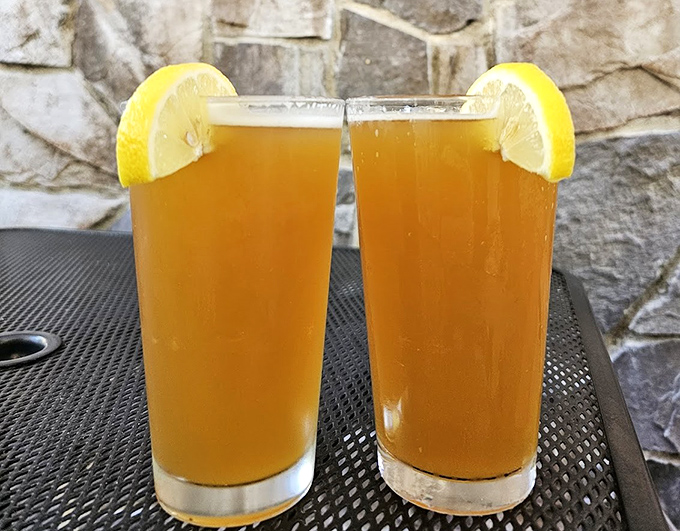 Two glasses of liquid sunshine with lemon accessories&mdash;the perfect palate cleanser between bites of burger bliss.