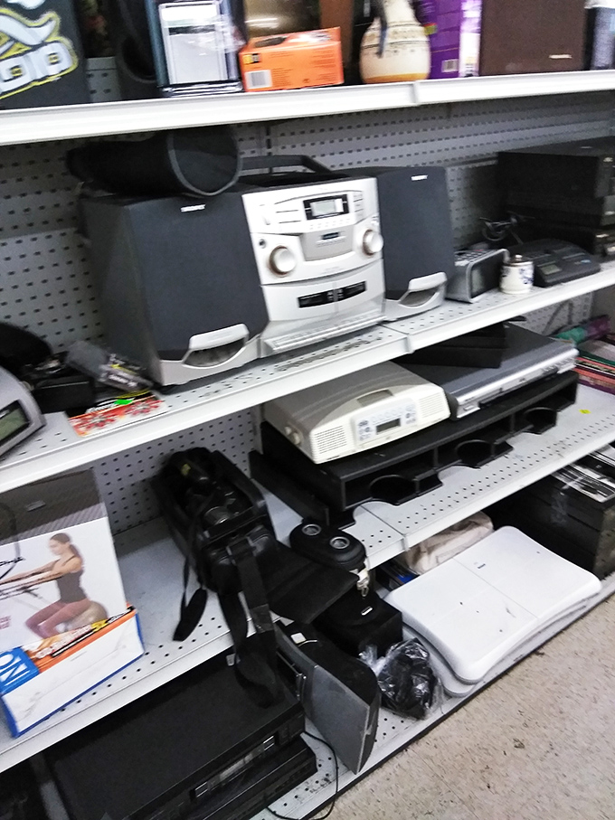 The electronics graveyard where stereo systems and DVD players enjoy their retirement, occasionally getting called back into service for nostalgic tech lovers.