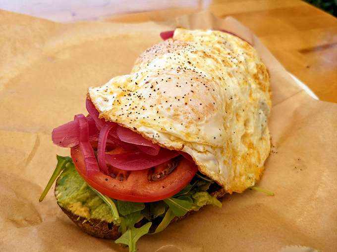 Breakfast meets California cool with this open-faced creation where the egg is perfectly cooked and pickled onions add that crucial zing.