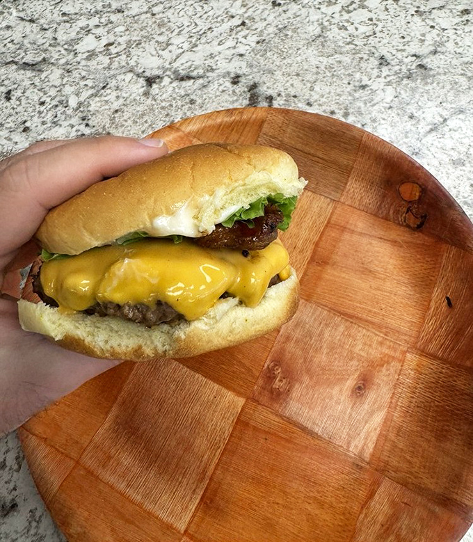 A cheeseburger caught in its natural habitat&mdash;simple, honest, and waiting to prove that sometimes the classics need no improvement.
