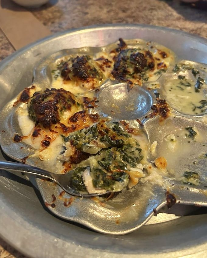 Baked oysters wearing their finest toppings—like little boats of flavor sailing straight into a sea of culinary bliss.