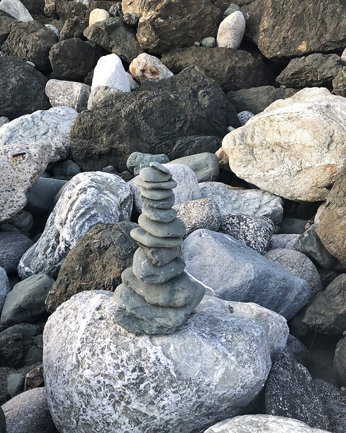 Rock balancing: the ancient art of making gravity question its life choices while creating ephemeral sculptures by the sea.