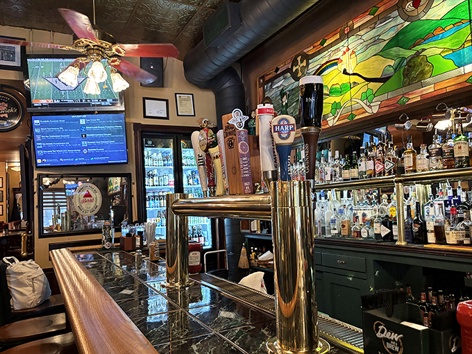 Behind the polished bar, an impressive array of spirits stands ready, with stained glass accents adding that authentic Irish pub glow.