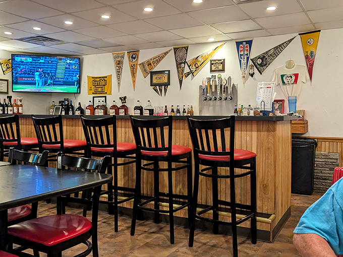 The bar area doubles as a shrine to Pittsburgh sports history. Every championship and heartbreak remembered over countless slices.