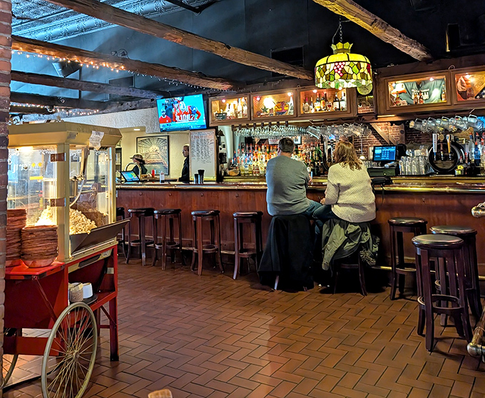 A popcorn machine stands sentinel at the bar – the universal signal that you're among friends who understand proper drinking accompaniments.