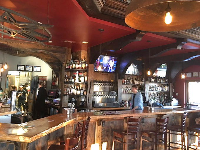 A bar that means business – gleaming wood, impressive bottle selection, and bartenders who look like they know the difference between shaking and stirring.