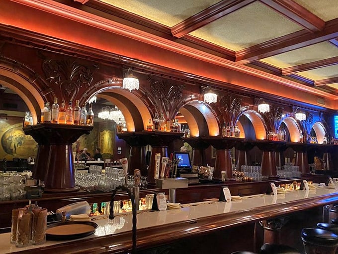 The magnificent bar with its arched woodwork could be from a Hollywood Western set. Bottles gleam like treasures under perfect lighting.