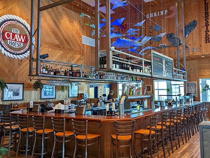 The bar area combines rustic charm with maritime flair&mdash;blue fish sculptures suspended above, promising libations that complement the day's catch.