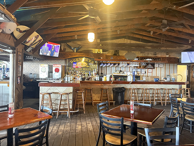 The bar stands ready for duty like a trusted first mate, with bottles gleaming and barstools that have supported generations of sunset-watchers. 