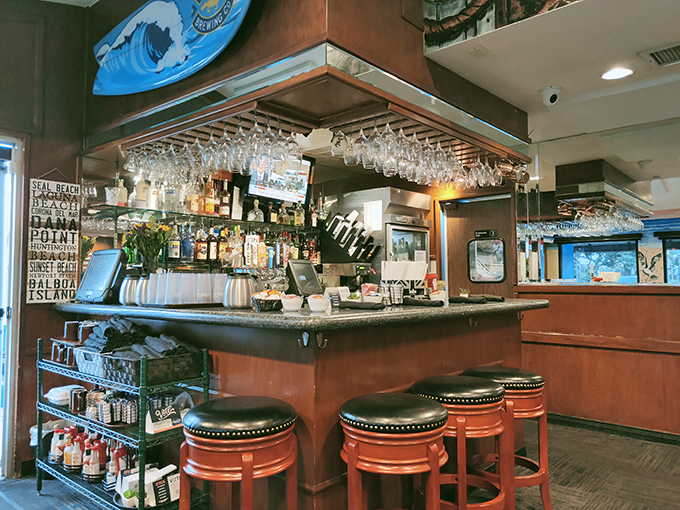 The bar area offers a front-row seat to the breakfast action, where surfboards and local memorabilia create that quintessential SoCal vibe.