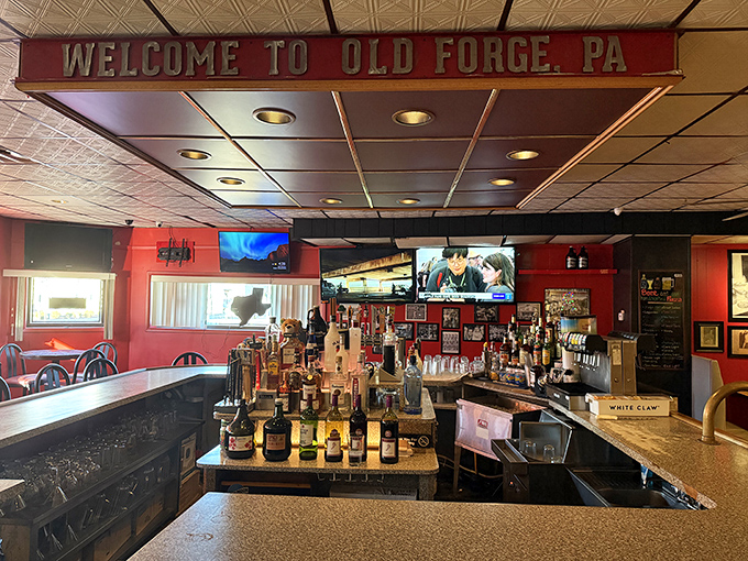 "Welcome to Old Forge, PA" announces the sign above the bar, where bottles stand at attention, ready to complement the town's famous pizza.