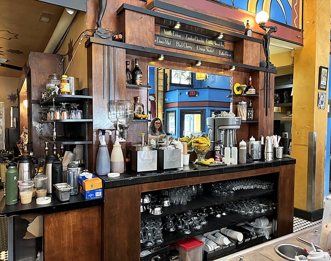 The bar area balances function and fantasy—where serious cocktail crafting happens beneath whimsical Art Deco flourishes.