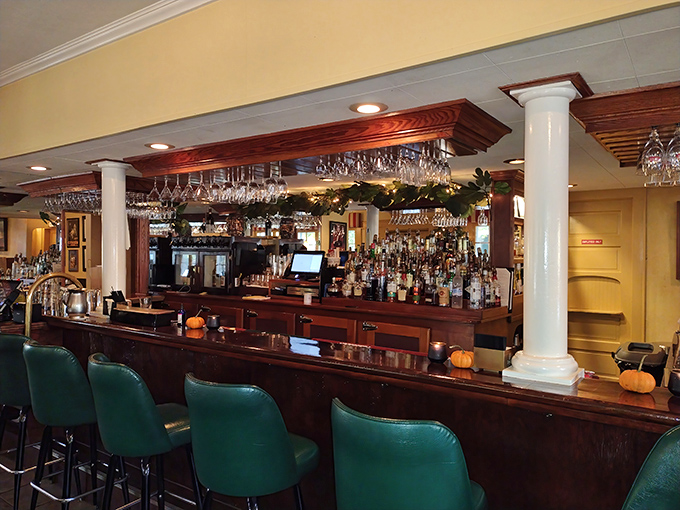 The bar area gleams with promise, where hanging glasses catch the light like crystal chandeliers waiting for their moment to shine.