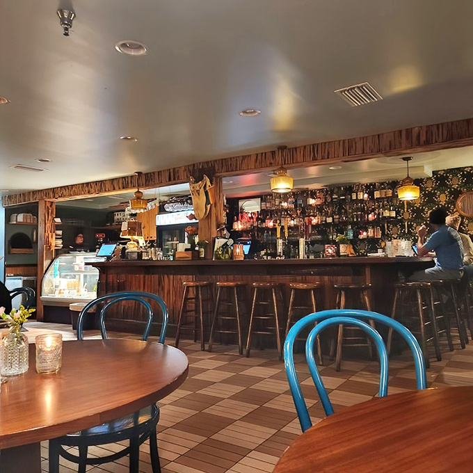 The bar area beckons with promises of perfectly crafted cocktails and meaningful conversations over dinner.
