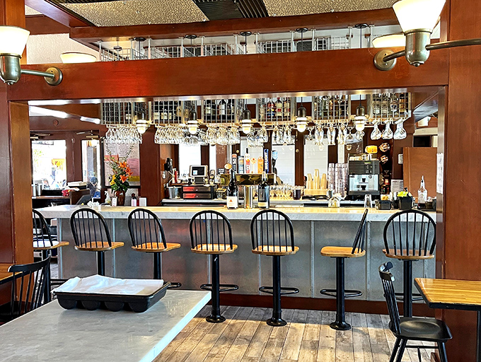 The bar area beckons with promises of craft cocktails and front-row seats to the mixology magic show.