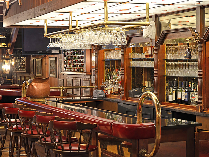 The bar gleams with promise&mdash;hanging glassware catching the light while rich wood and brass details create that classic steakhouse elegance we all crave.