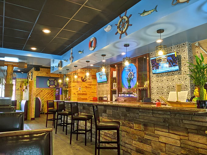 The bar area combines rustic stone with nautical flair. Like a beach shack that went to design school but kept its soul.