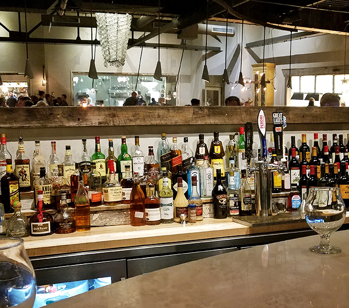 A bar stocked like an adult candy store, where bottles gleam with promise and bartenders stand ready to mix liquid happiness.