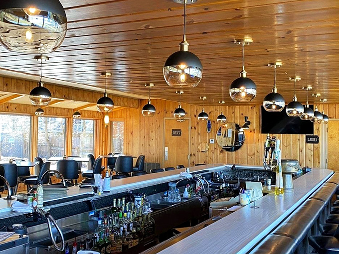 The bar area gleams with pendant lights reflecting off polished wood. Those globe lights could double as crystal balls predicting your evening's happiness.