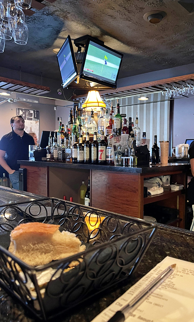 The bar's impressive bottle display isn't just inventory&mdash;it's a promise of possibilities, from classic cocktails to creative concoctions.