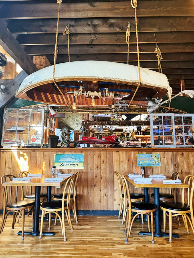 Vintage wooden boat hanging above diners&mdash;because nothing enhances appetite like the subtle reminder that you're eating beneath a suspended vessel.