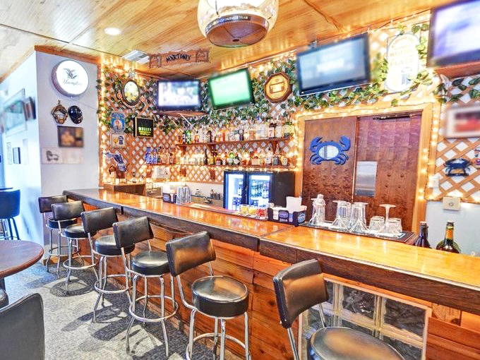 The bar area combines rustic wood with nautical touches&mdash;where cold drinks and warm conversation create the perfect Florida evening.