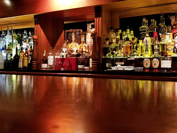 A bar top gleaming with amber promise. This is where decisions are made, celebrations begin, and sometimes, the best part of the evening unfolds.
